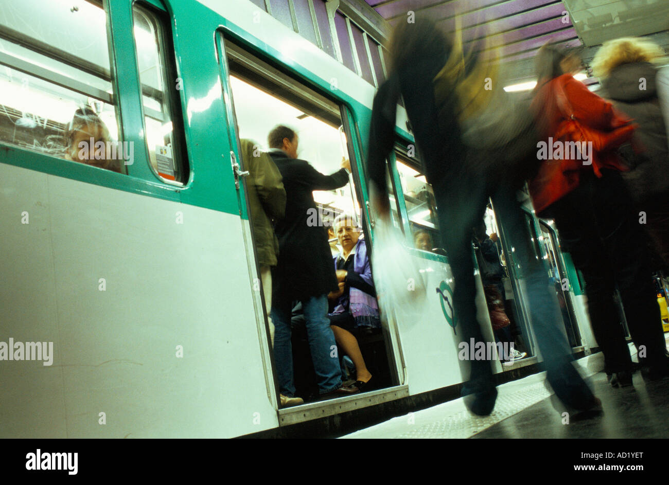 People waiting and getting on trains at the Metro Station at Barbes ...