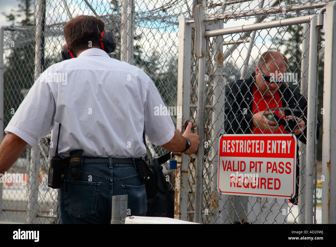 Car racing safety gate onto track Stock Photo - Alamy