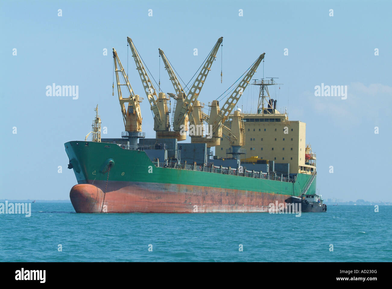 Empty bulk ship at anchor in tropical waters Stock Photo - Alamy