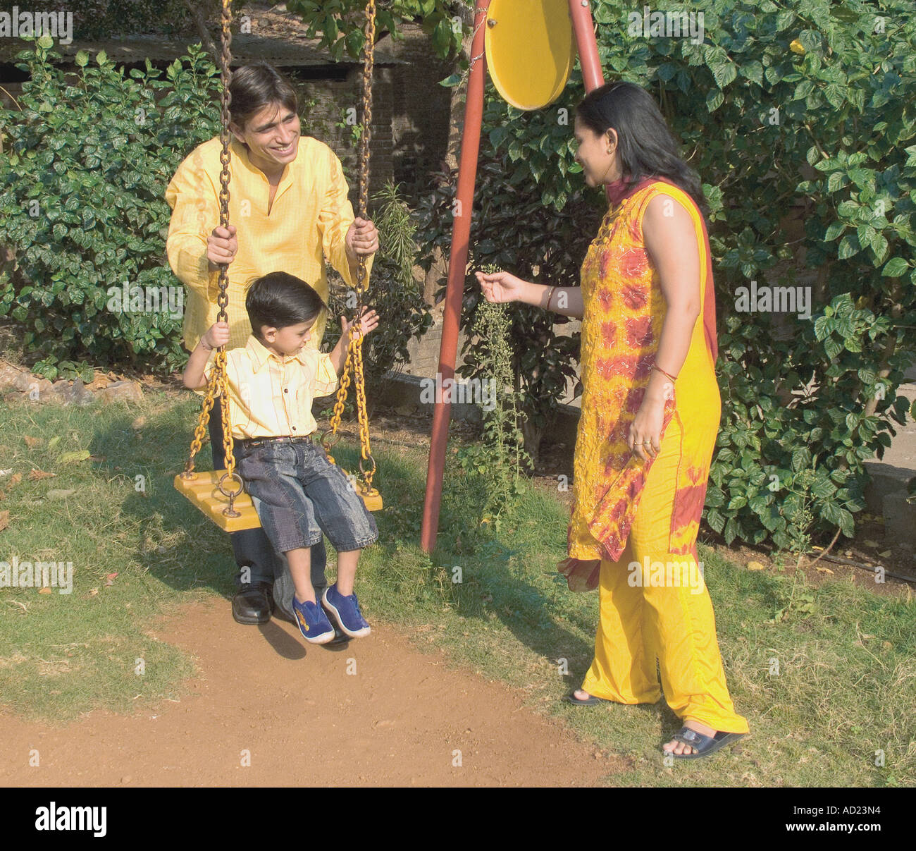 AHP72772 Family Religion Parsi Zorastrian parents playing with the ...