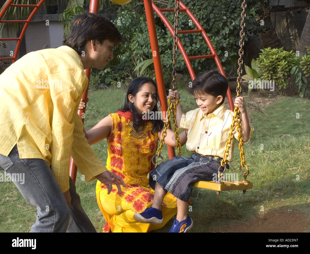 AHP72775 Family Religion Parsi Zorastrian Father Mother son on swing ...