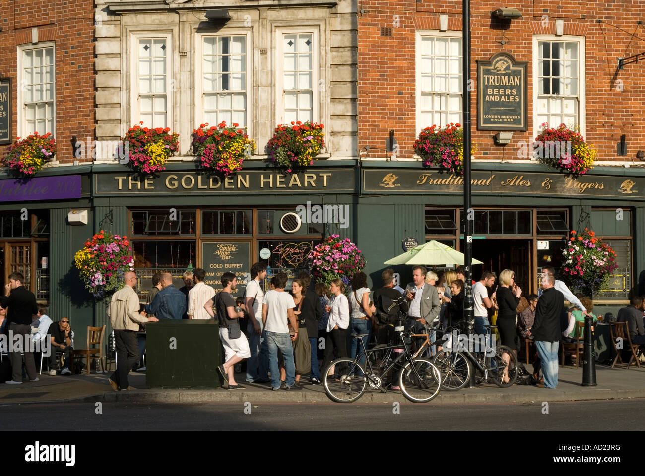 People drinking outside the Golden Heart pub in Spitalfields in the ...