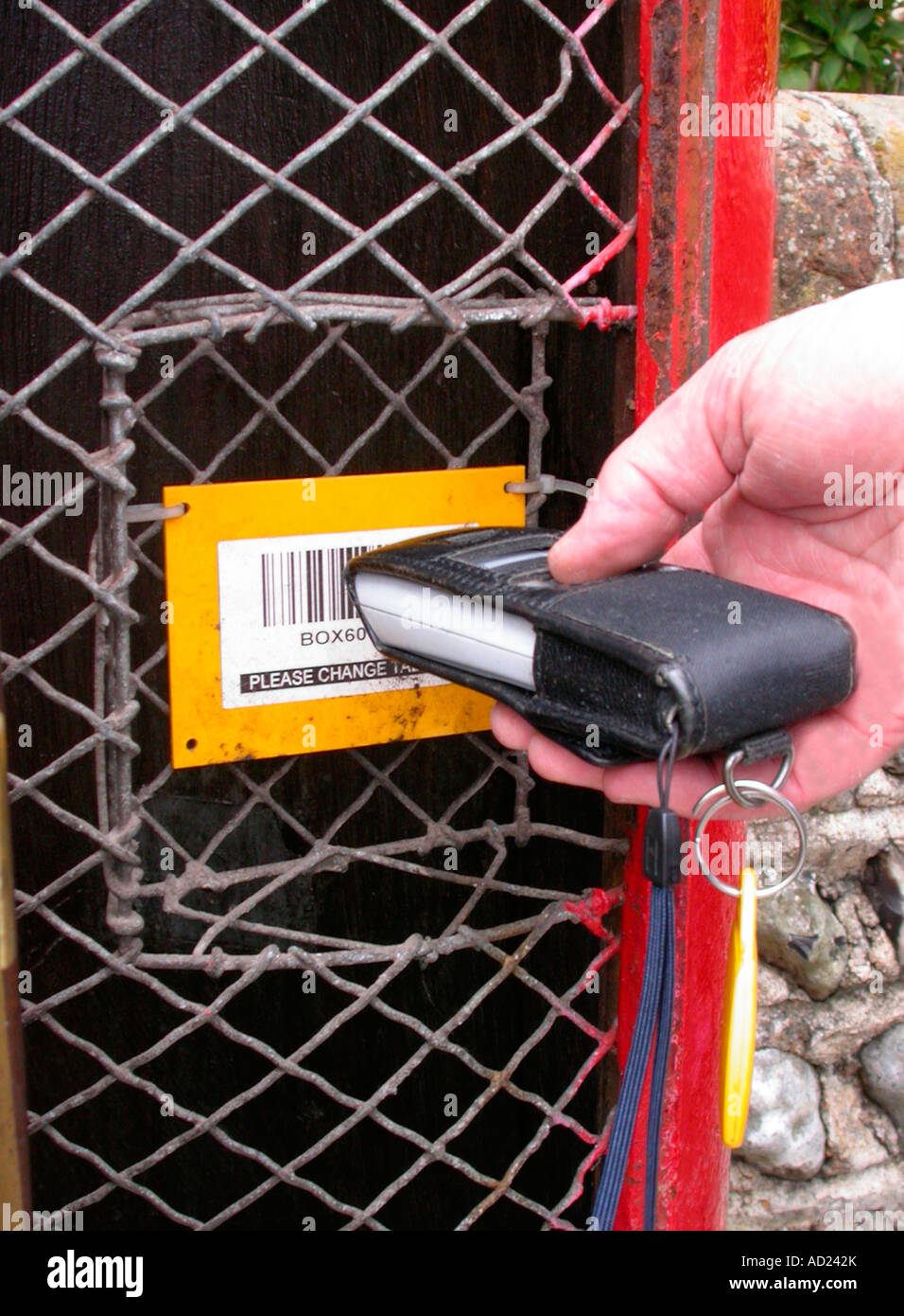 postman barcoding prior to emptying letter box Stock Photo - Alamy