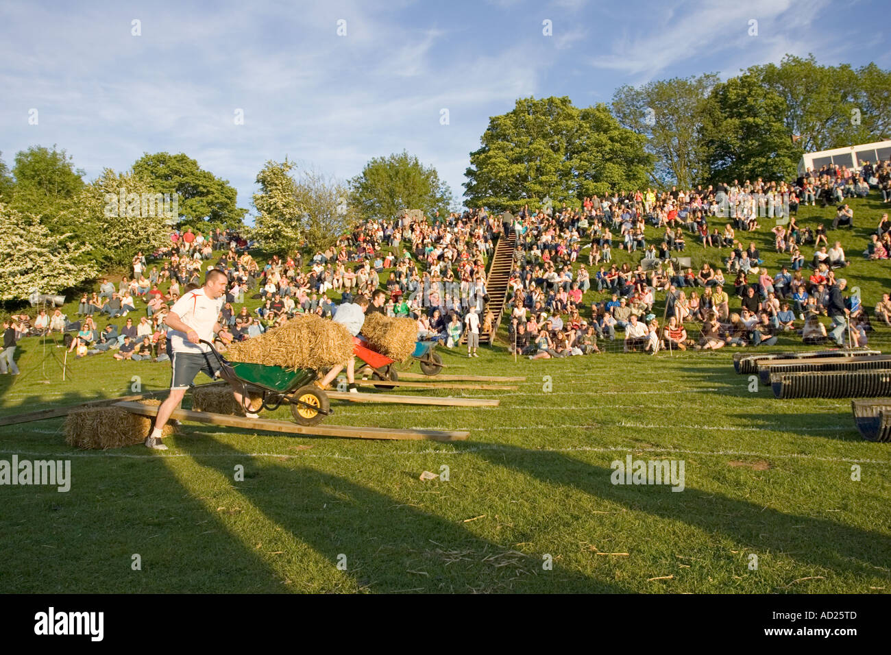 Straw bale wheelbarrow race at Cotswold Olimpicks Dovers Hill Cotswolds ...
