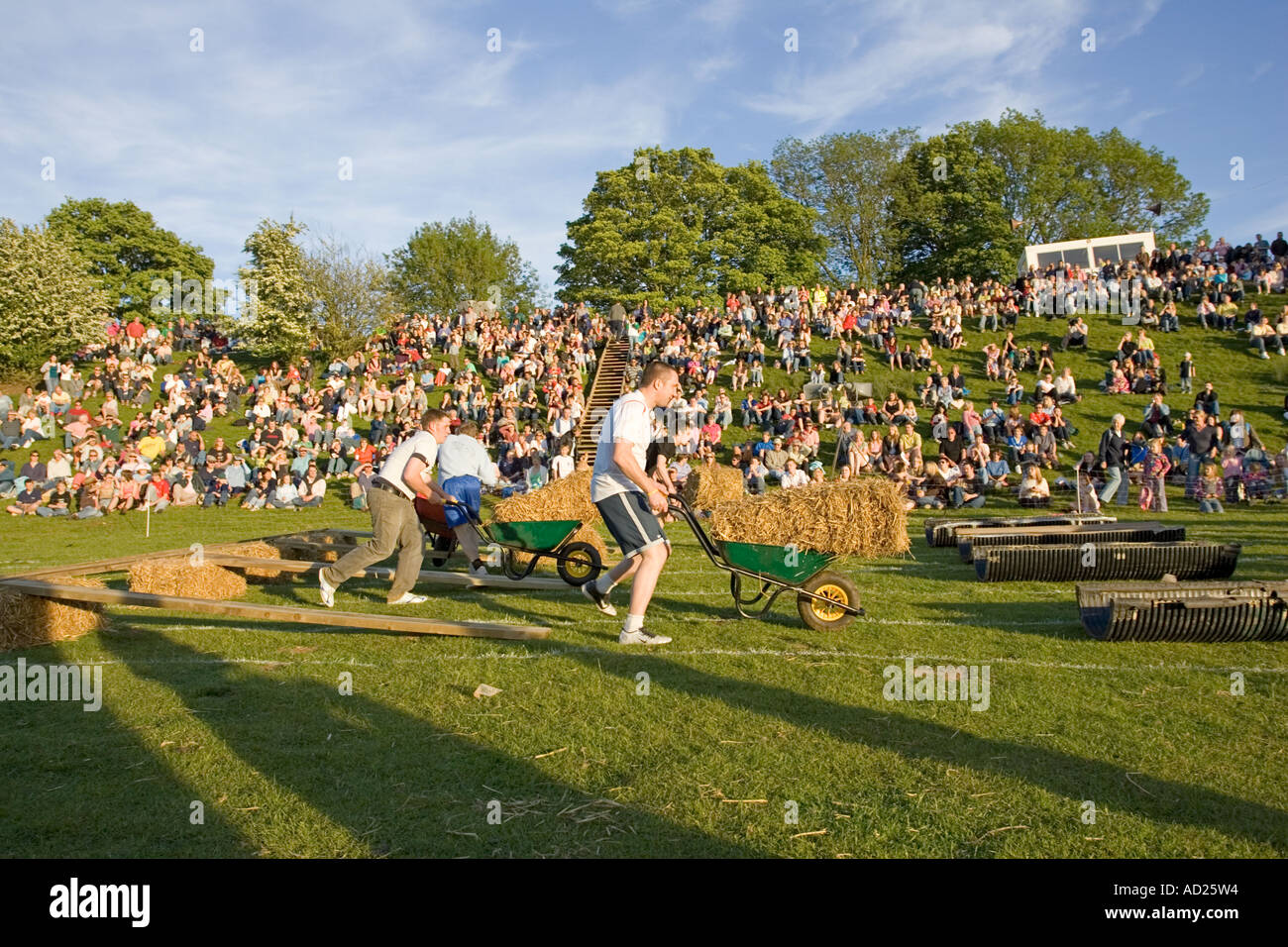 Straw bale wheelbarrow race at Cotswold Olimpicks Dovers Hill Cotswolds ...