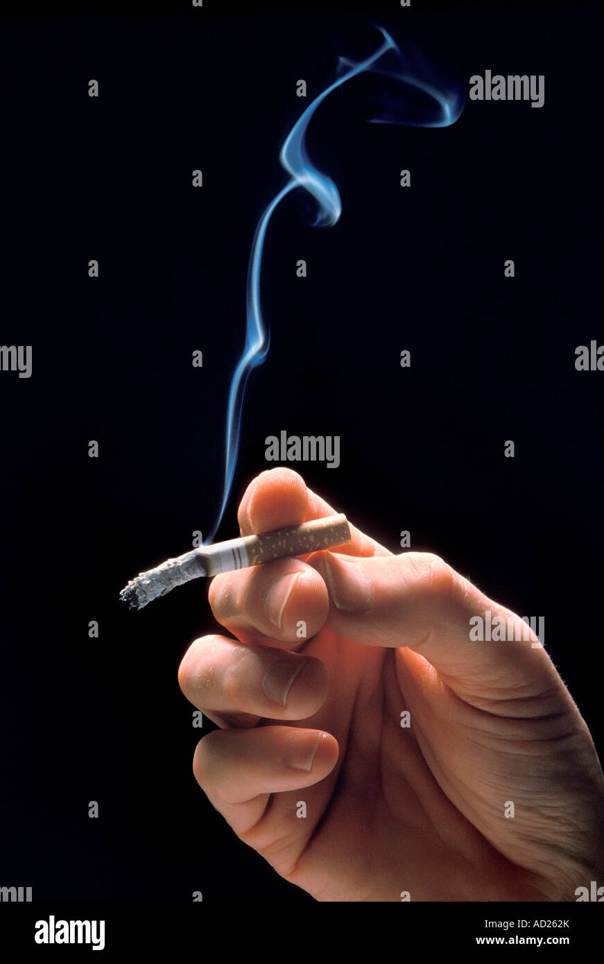 hand holding lighted cigarette Stock Photo - Alamy