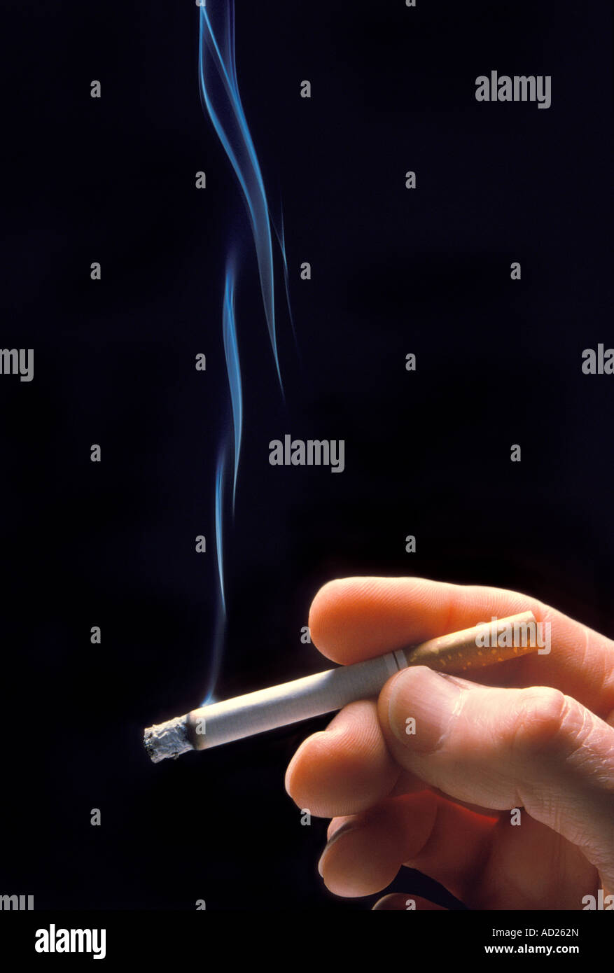 hand holding lighted cigarette Stock Photo - Alamy