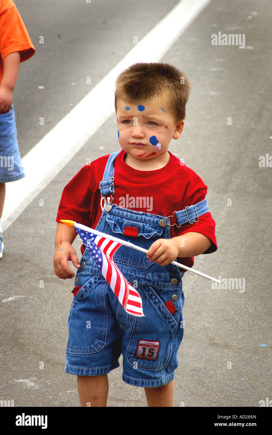 Little boy marches with American flag 4th of July parade in Huntington ...