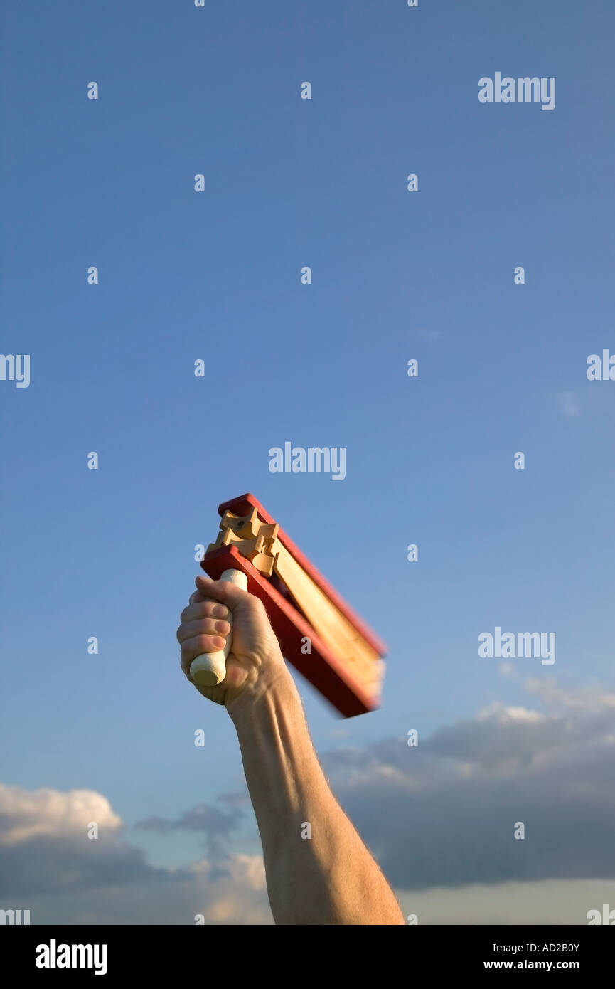 Hand waving a traditional football rattle in the air Stock Photo - Alamy