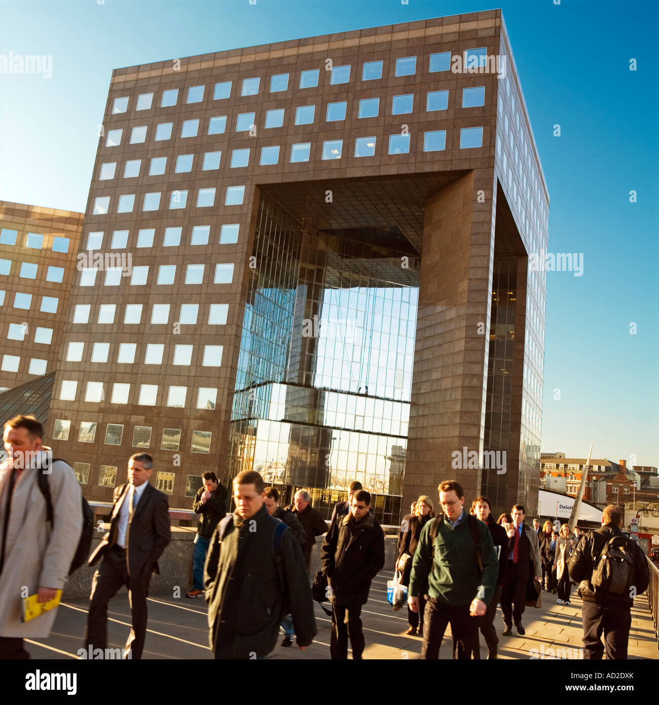 Going to work early morning office workers walking over London Bridge ...