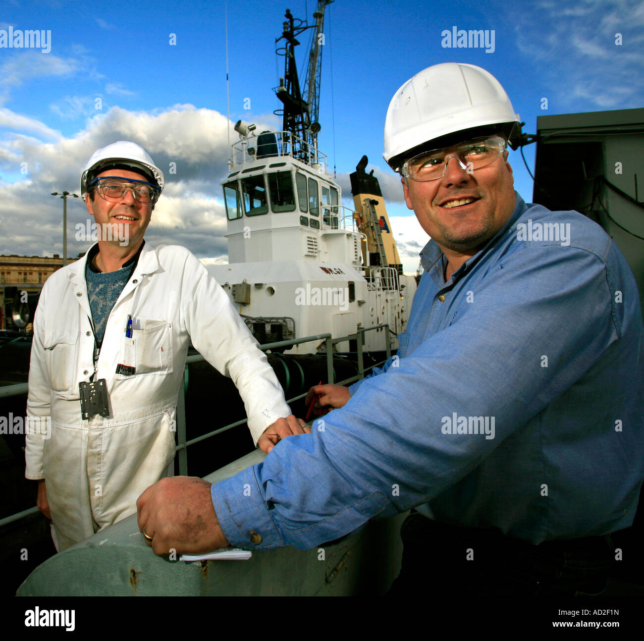 Men with safety helmets and glasses in shipyard Stock Photo - Alamy