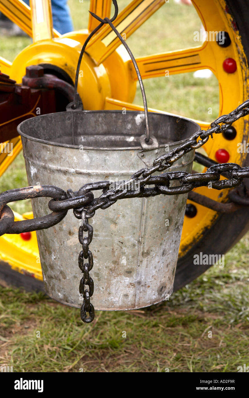 Wheel and water bucket beneath a showmans engine at a steam rally Stock ...