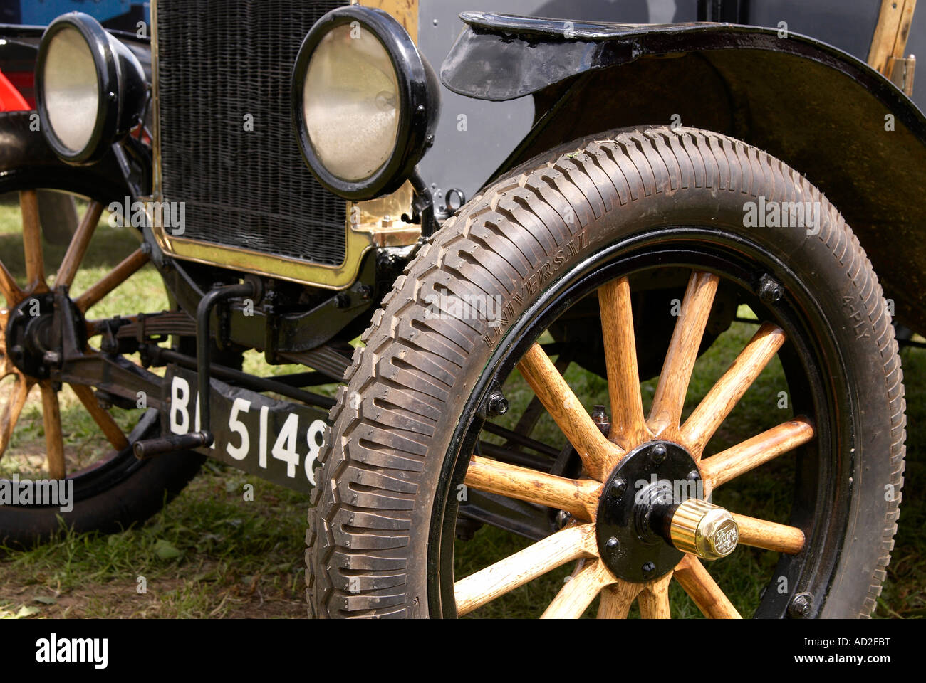 Wheel, headlamps and grill of Ford Model T van at a vintage rally ...