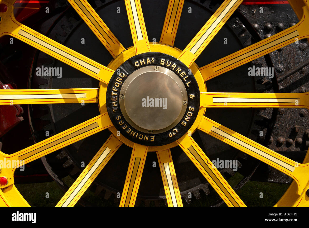 Bright yellow wheel and spokes of a Burrell showmans engine at a steam ...