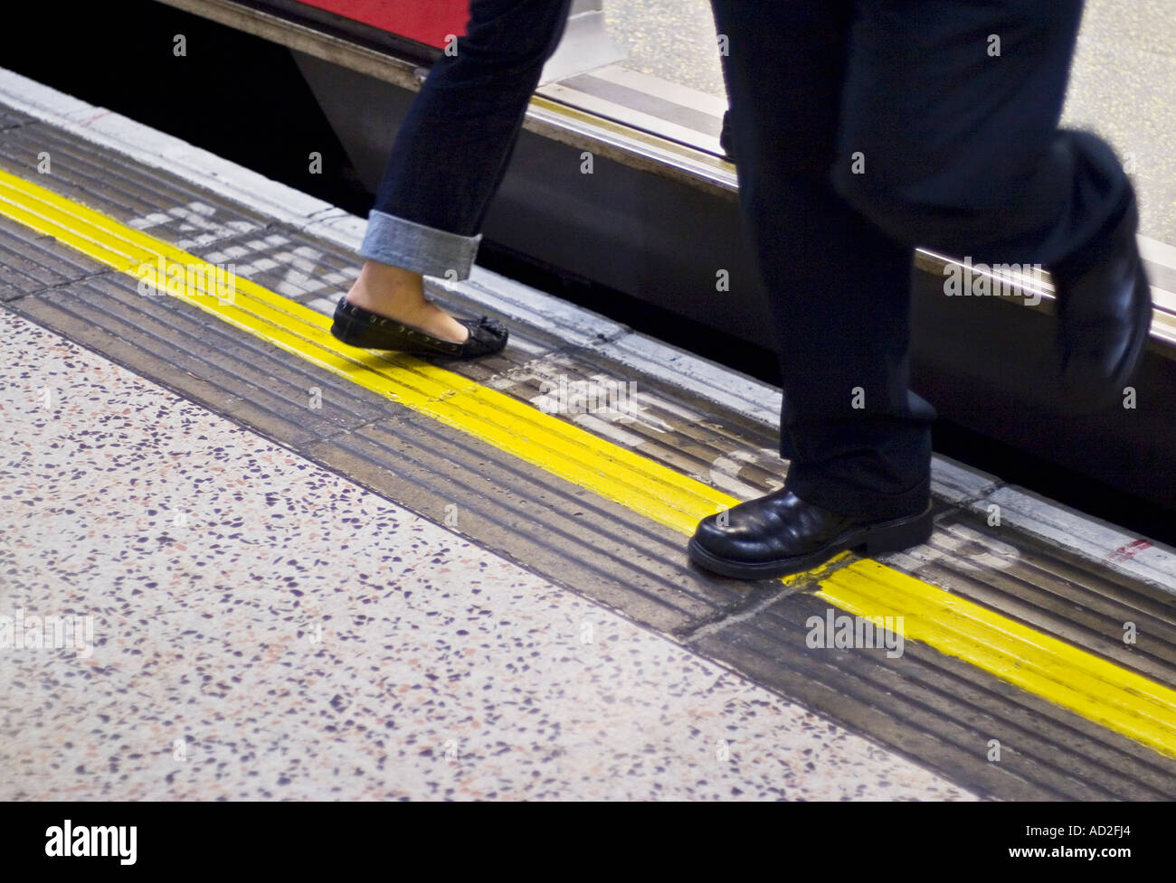 Businessman steps off tube train on London Underground platform whilst ...