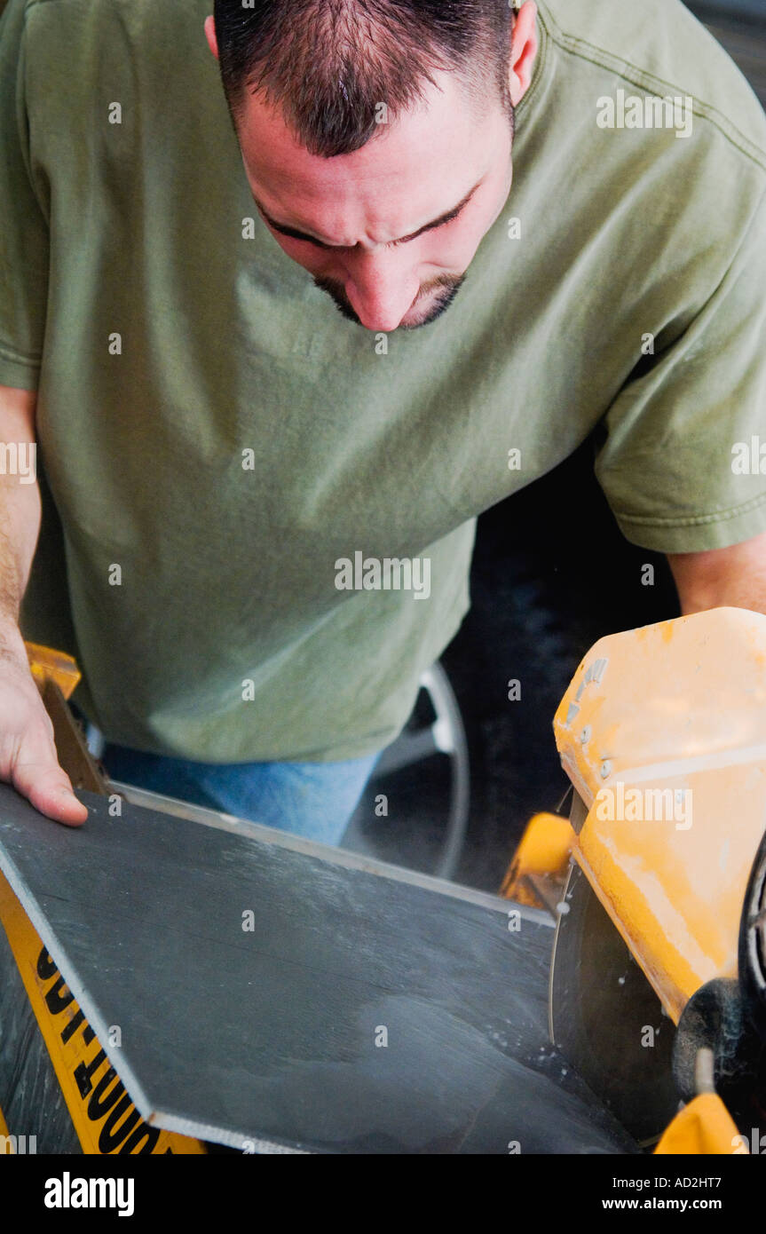 Man cutting tile with saw Stock Photo - Alamy