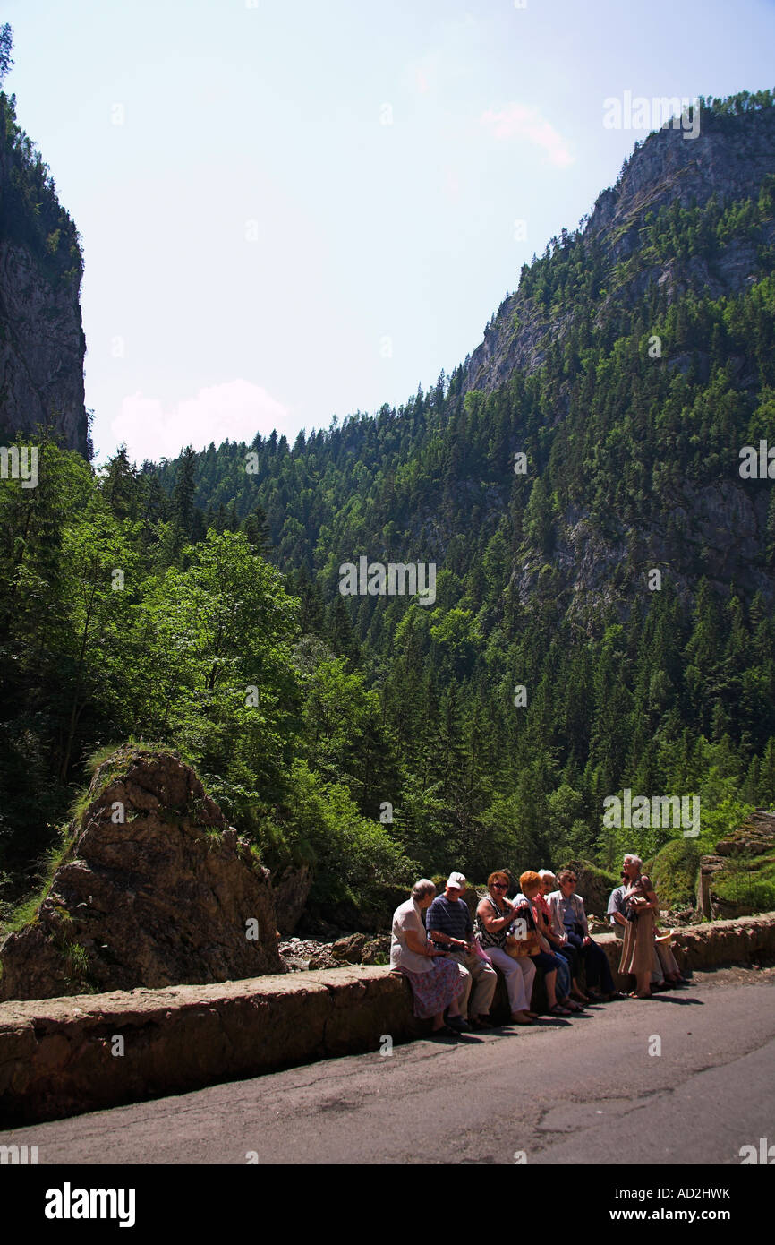 Tourists sitting on wall in Bicaz Gorge, Cheile Bicazului Hasmas ...