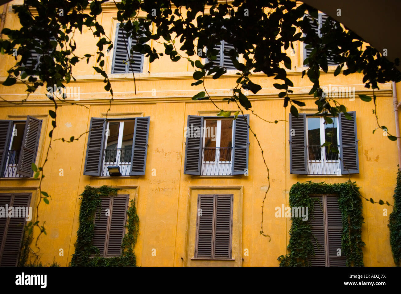 Windows shutters and yellow wall Rome Italy Stock Photo - Alamy