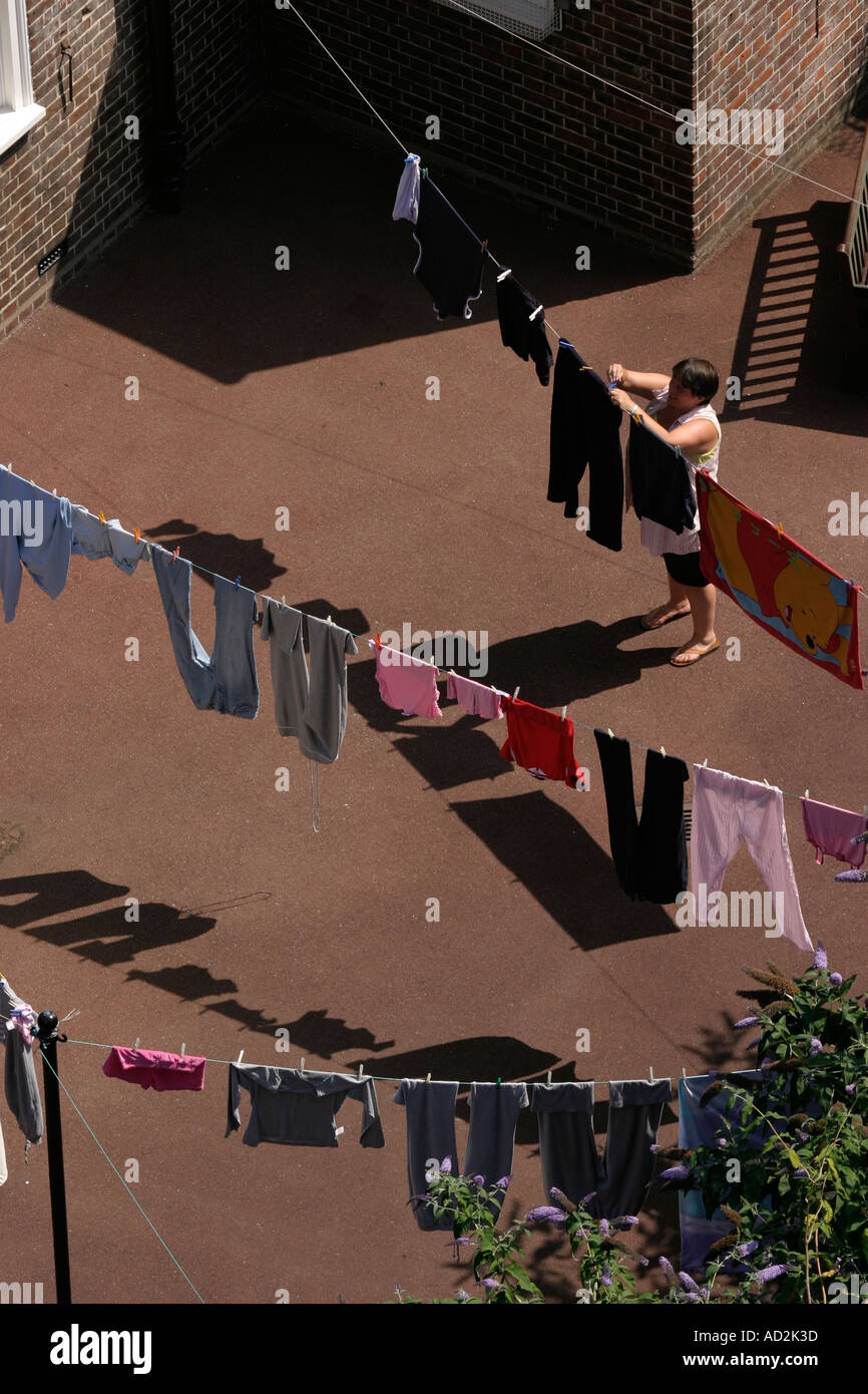 Woman hanging clothes to dry London England UK Stock Photo - Alamy
