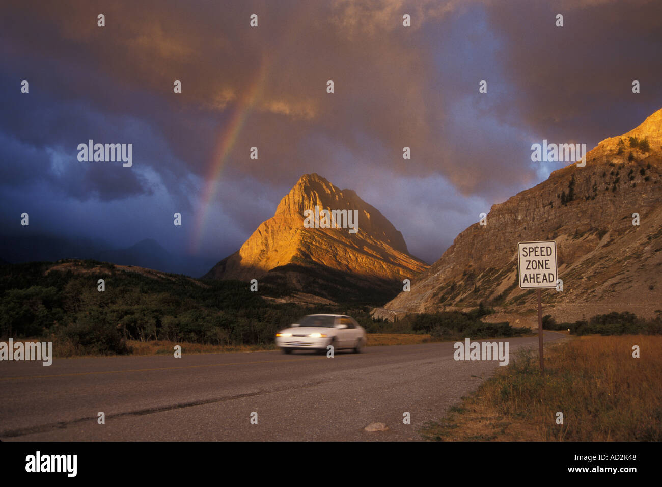 Mt Gould and a rainbow from Many Glacier Road in Glacier National park ...