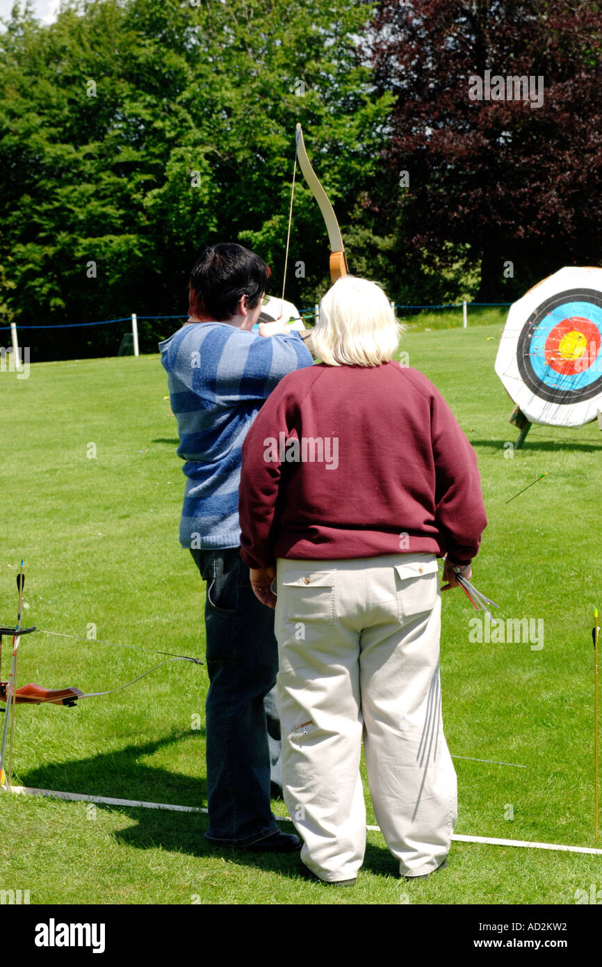 A man learning the art of Archery with a trained instructor Stock Photo ...