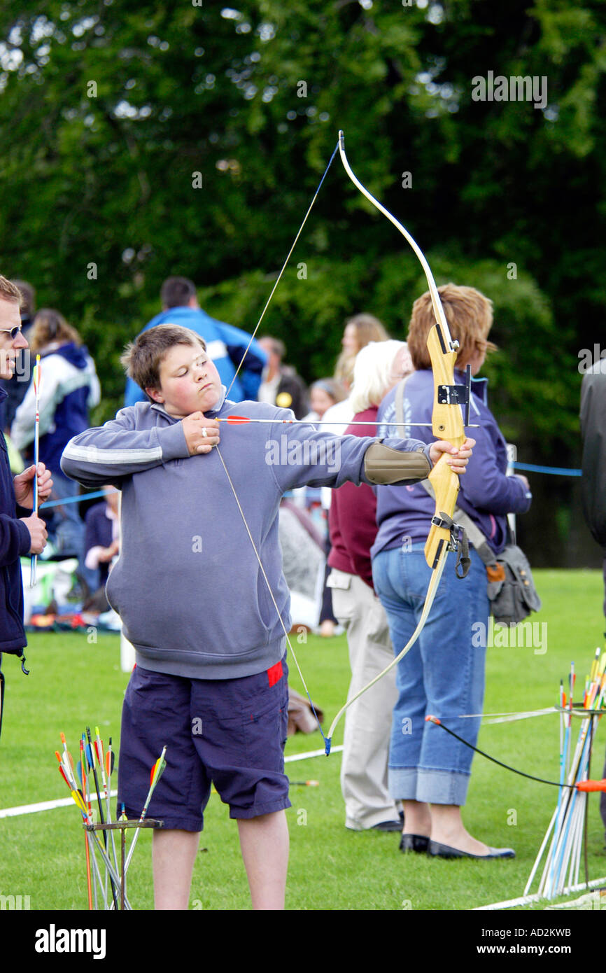 A young man learning the art of Archery with a trained instructor Stock ...