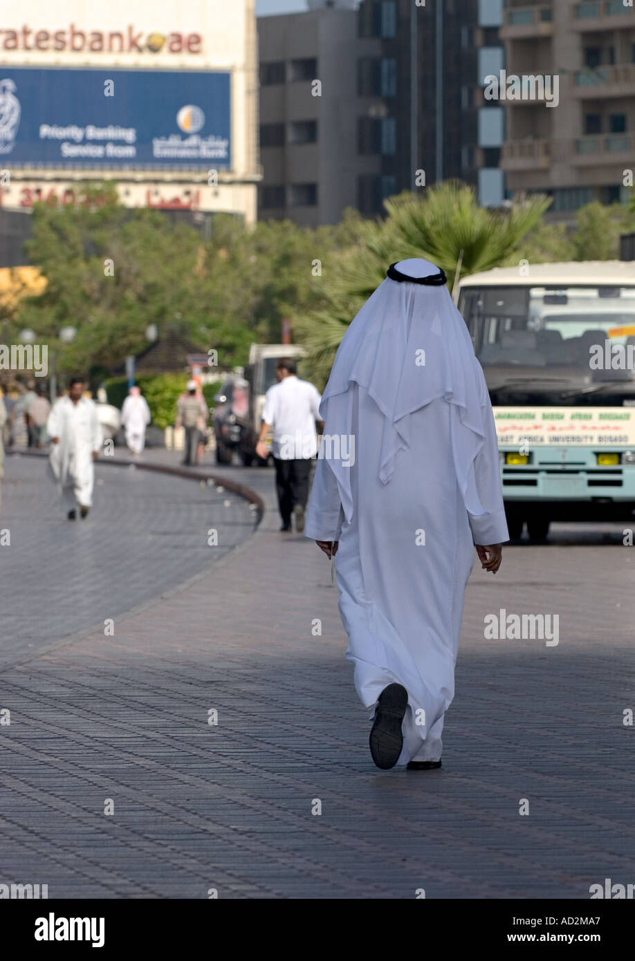 Man in arab costume walking in the streets of dubai Stock Photo - Alamy