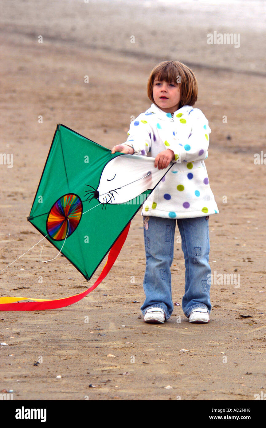 A pre-K female child holding a kite Stock Photo - Alamy