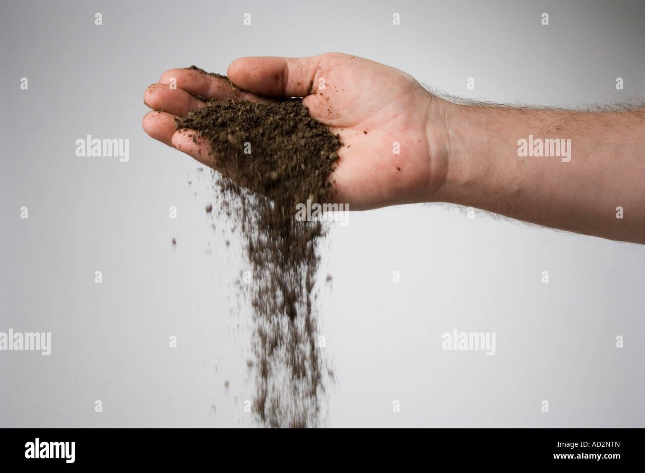 Soil or earth falling from a male hand Stock Photo - Alamy