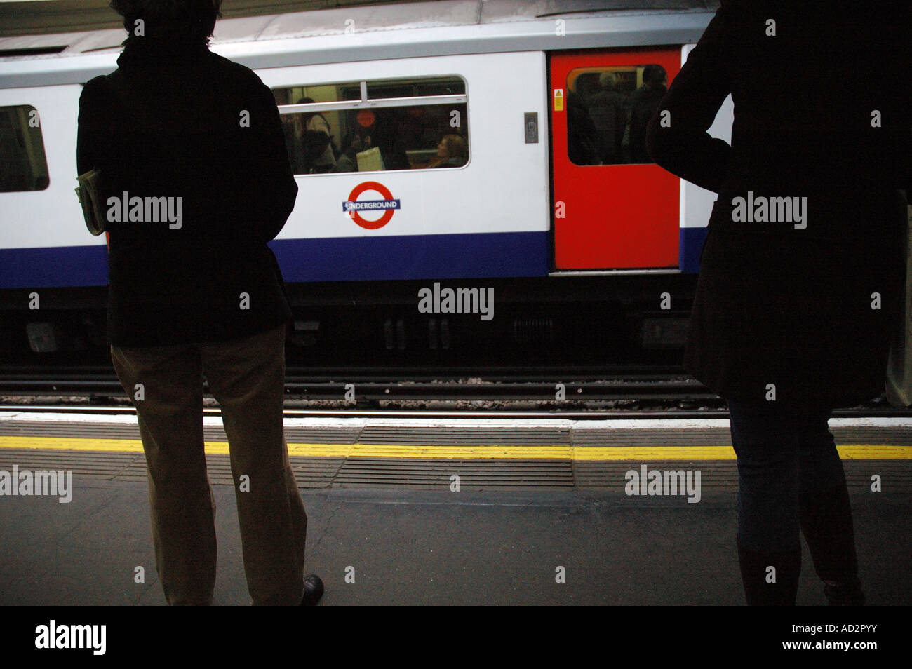 Rail commuters and train on British Station Stock Photo - Alamy