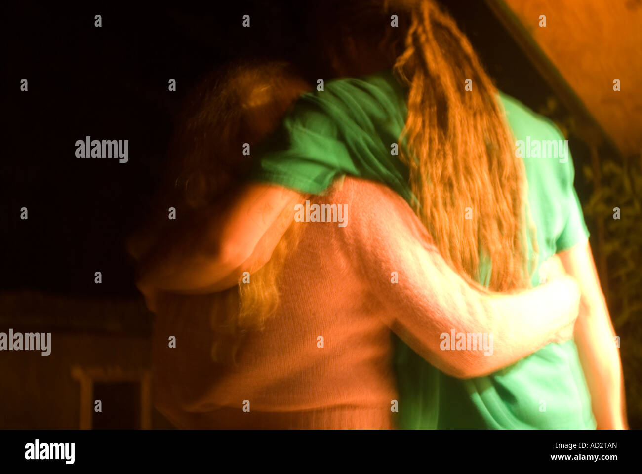 Two friends hug at night Stock Photo - Alamy