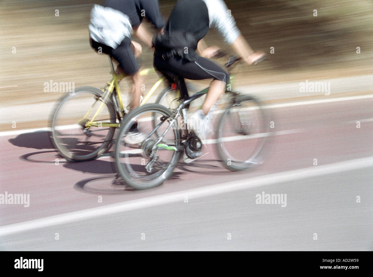 two cyclists on cycle path movement blurred Stock Photo - Alamy