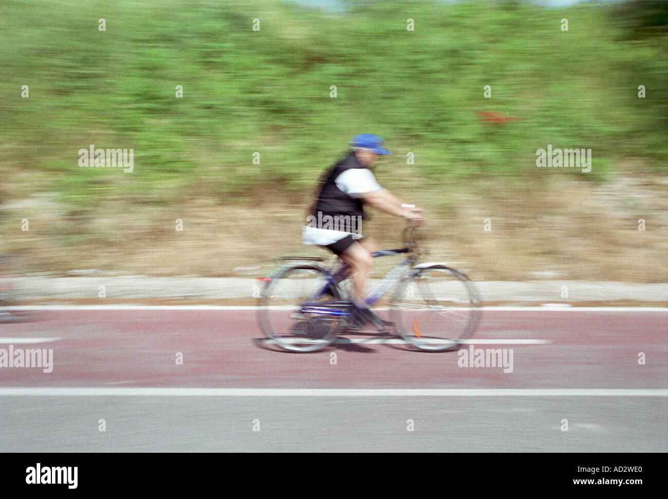 elderly man cycling on cycle path movement blurred Stock Photo - Alamy