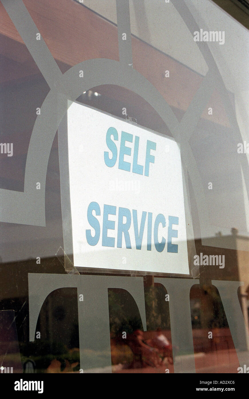 self service sign in shop window Stock Photo - Alamy