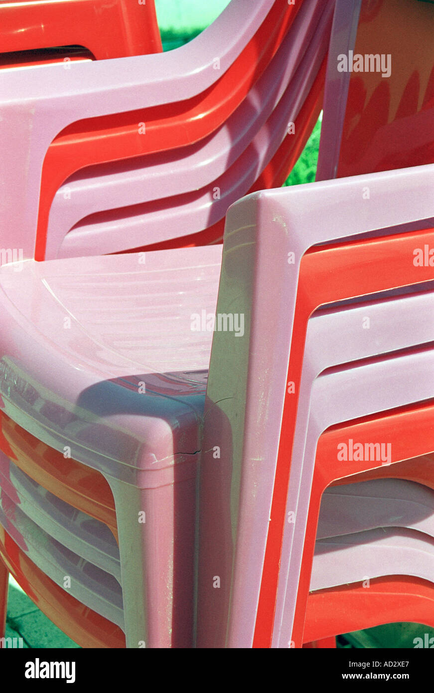 multicoloured stacked plastic chairs Stock Photo - Alamy