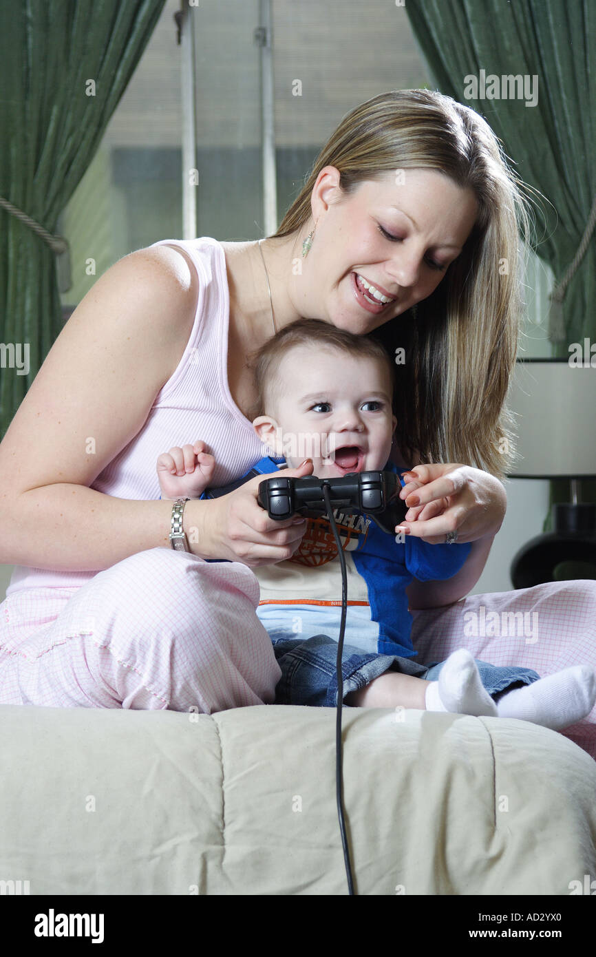 mother playing game on playstation with her son having fun Stock Photo ...