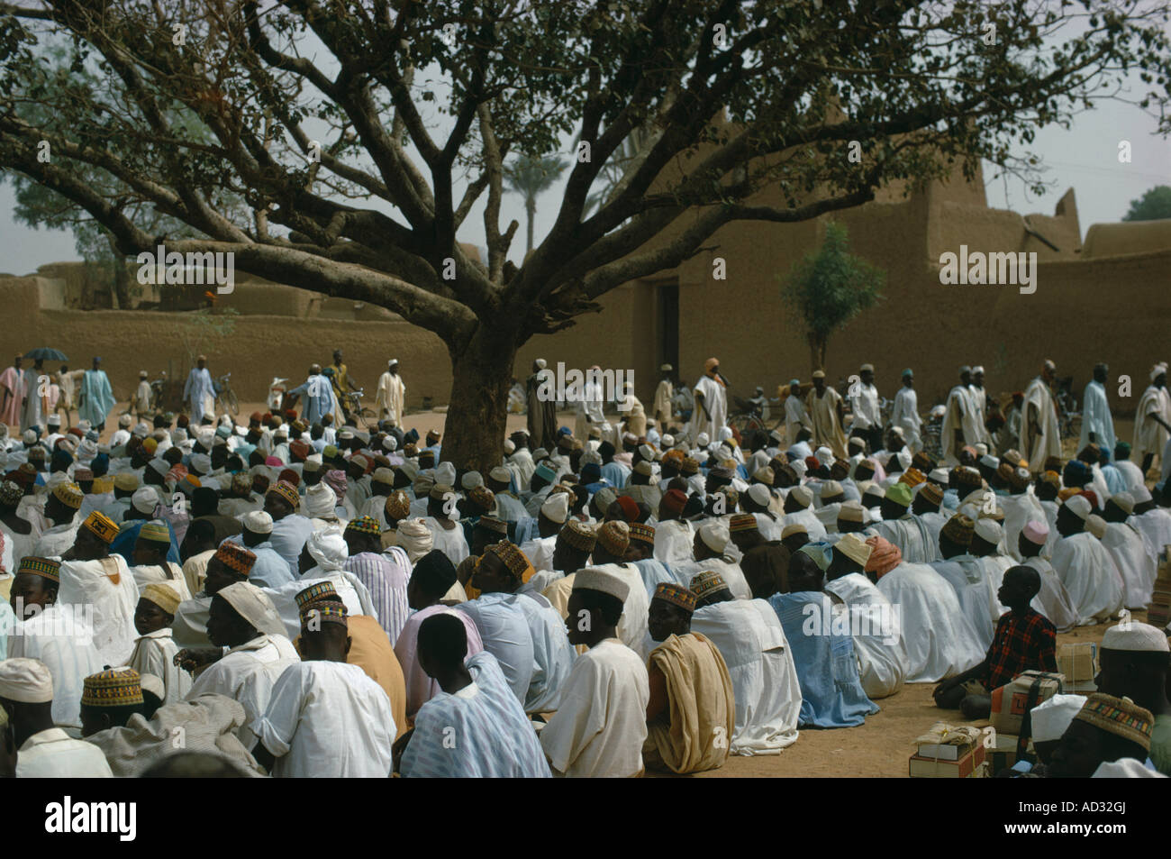 NIGERIA West Africa Kano Men Praying at prayer ground of mud brick ...