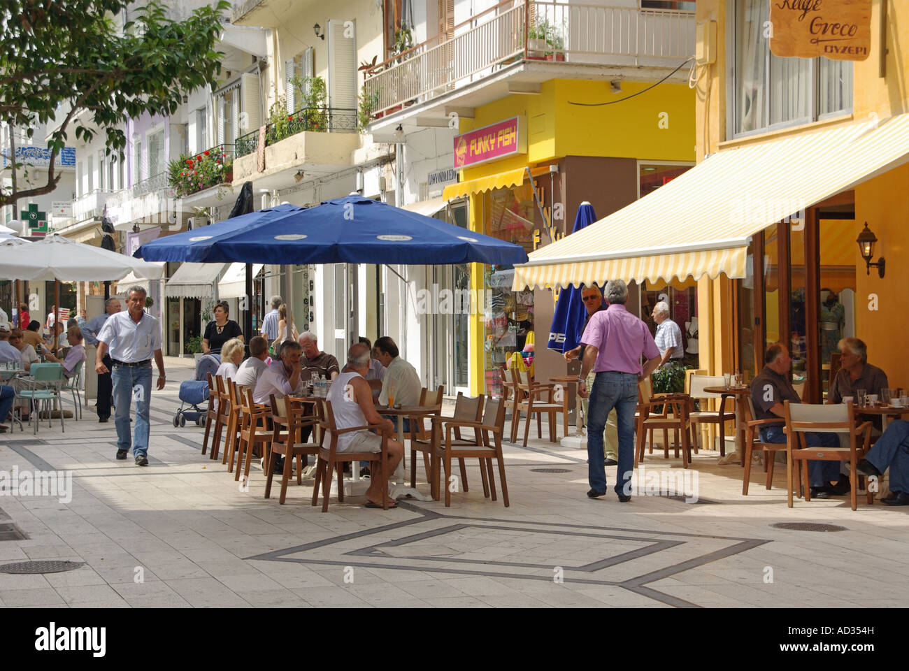 Igoumenitsa pedestrianised street people relaxing at pavement bars ...