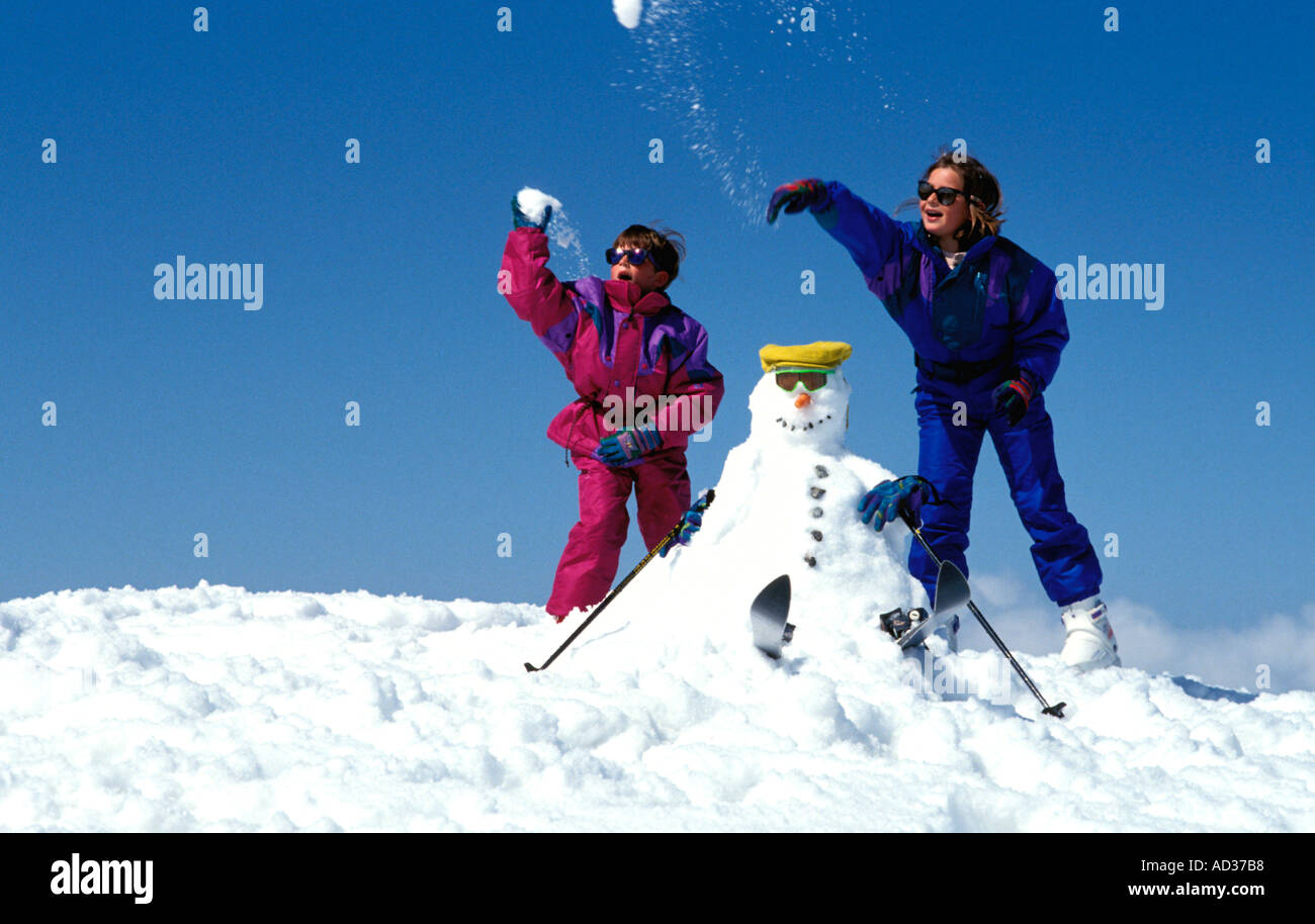 Children throwing snowballs hi-res stock photography and images - Alamy
