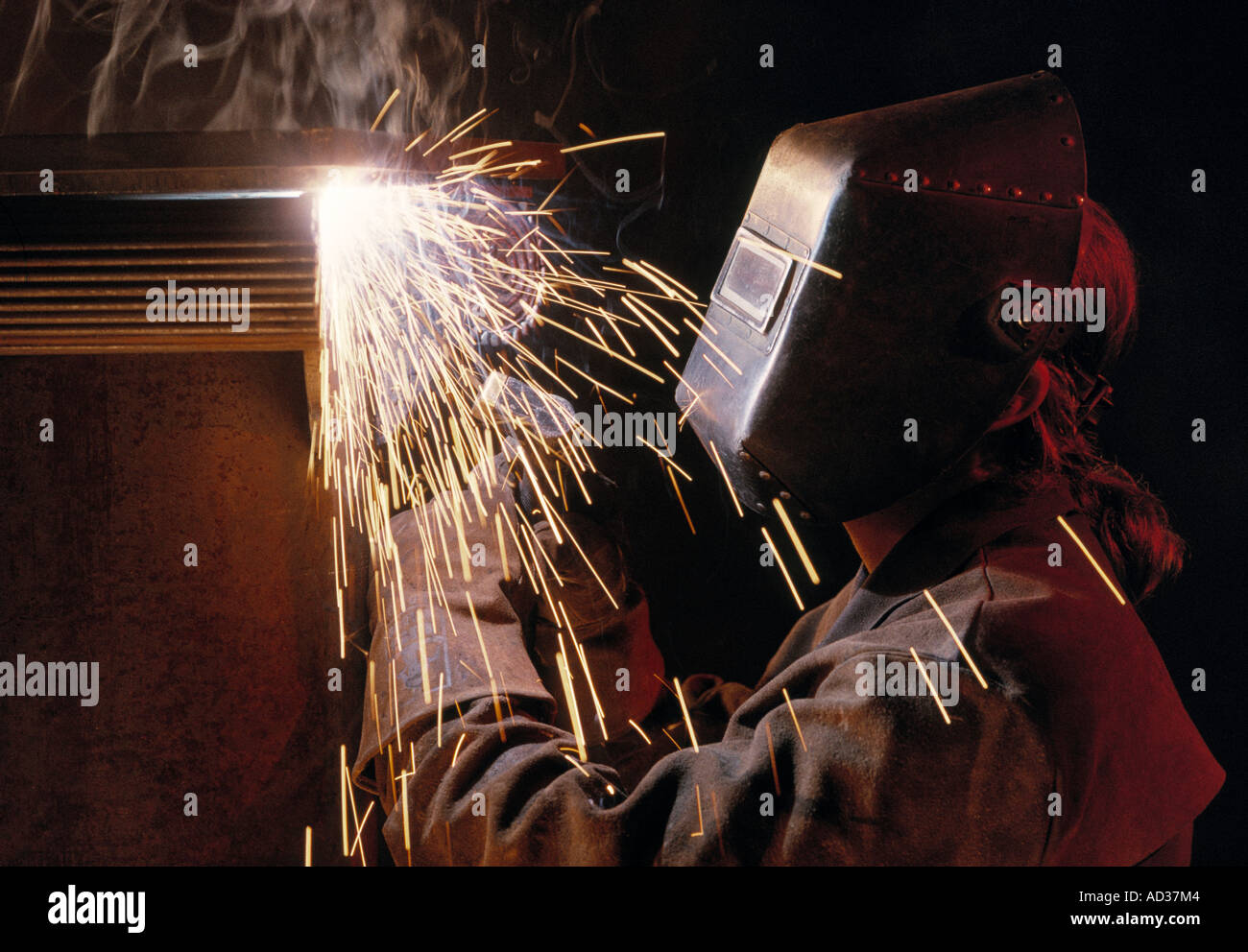 Man welding in mask on construction site Stock Photo - Alamy