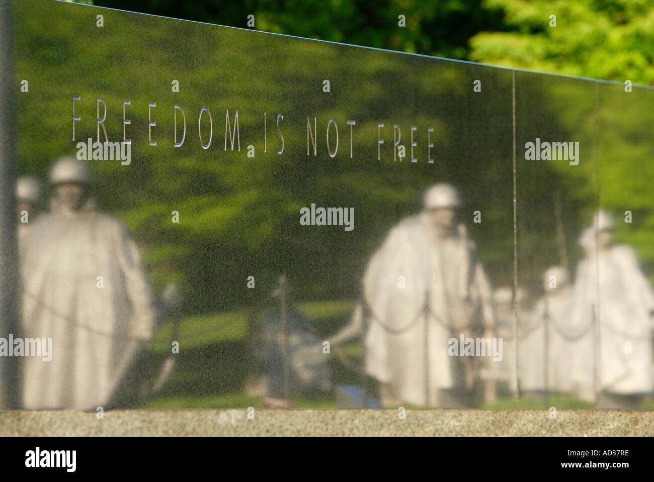 Words "Freedom is not free" carved on wall with soldier statues at the ...
