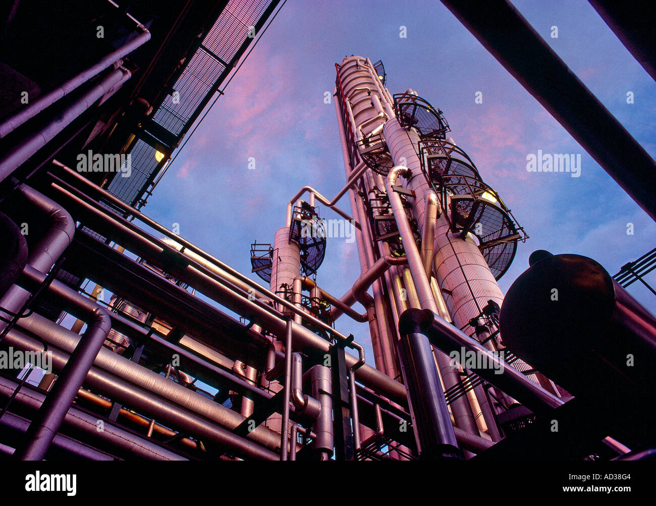 Oil refinery towers and pipes against a sunset sky Stock Photo - Alamy