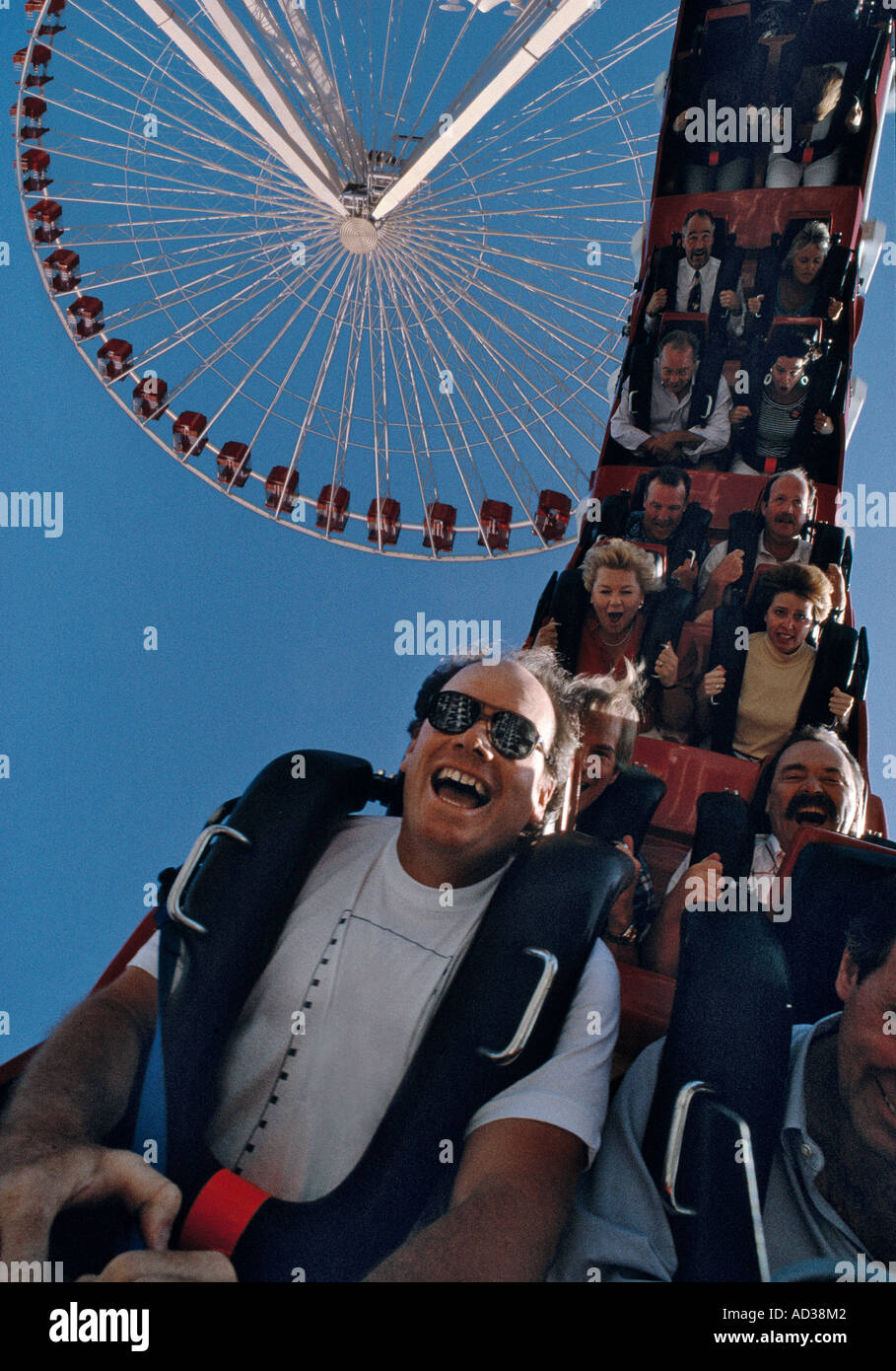 Man riding an upside down rollercoaster with a ferris wheel in the ...