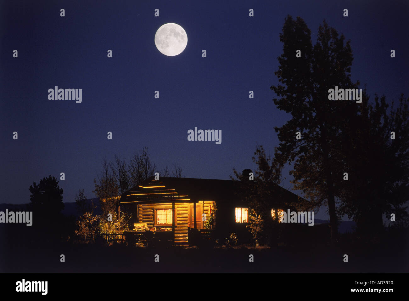 Full moon over mountain log cabin in Wyoming Stock Photo - Alamy