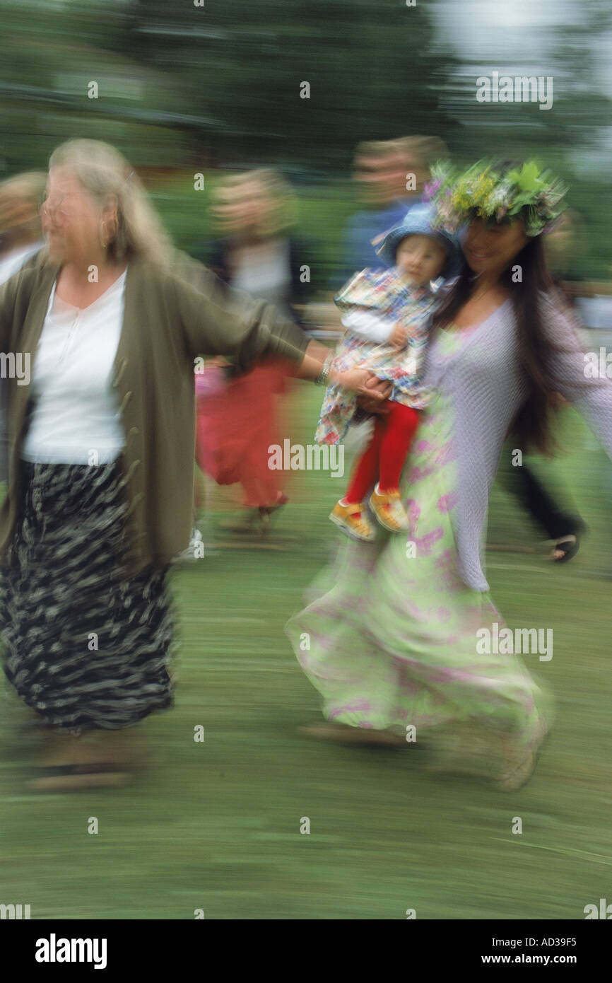 Parents and children dancing around Maypole during Midsummer ...