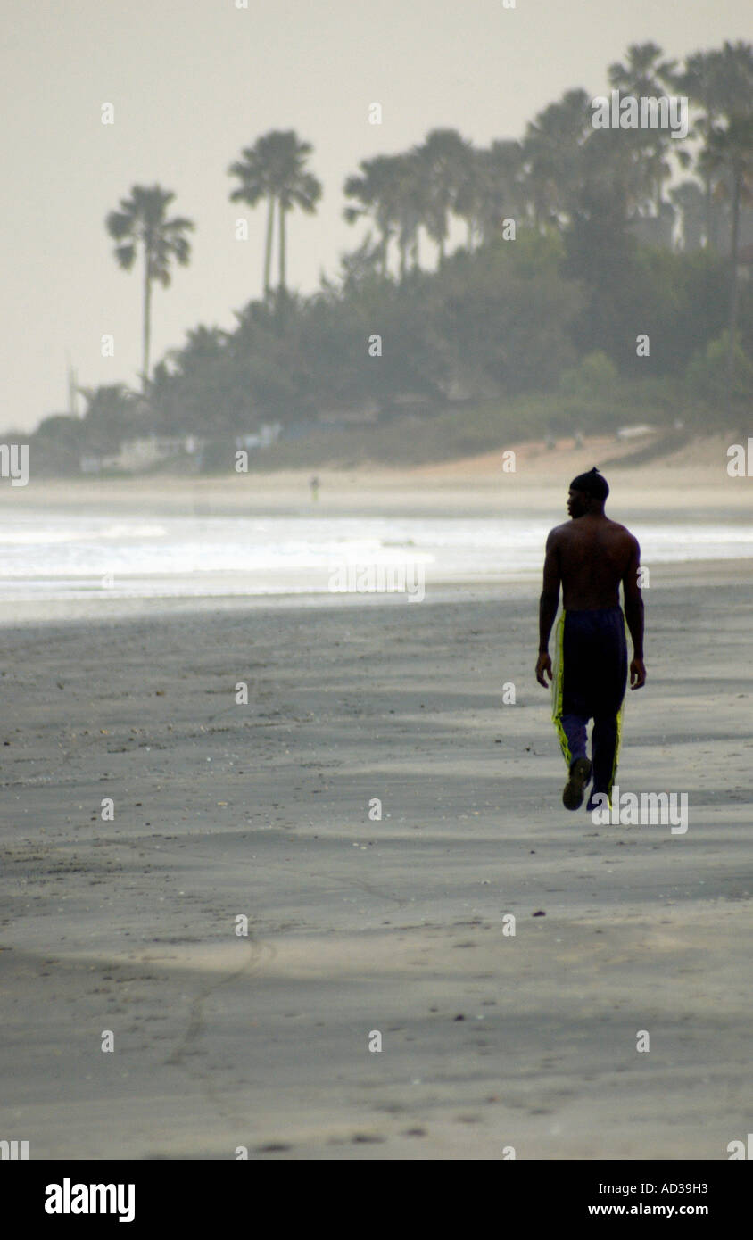 Man walking on Kombo Beach, The Gambia Stock Photo - Alamy