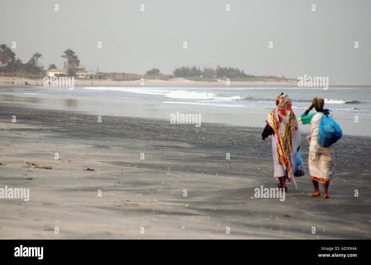 Two local women walking on Kombo Beach, The Gambia Stock Photo - Alamy