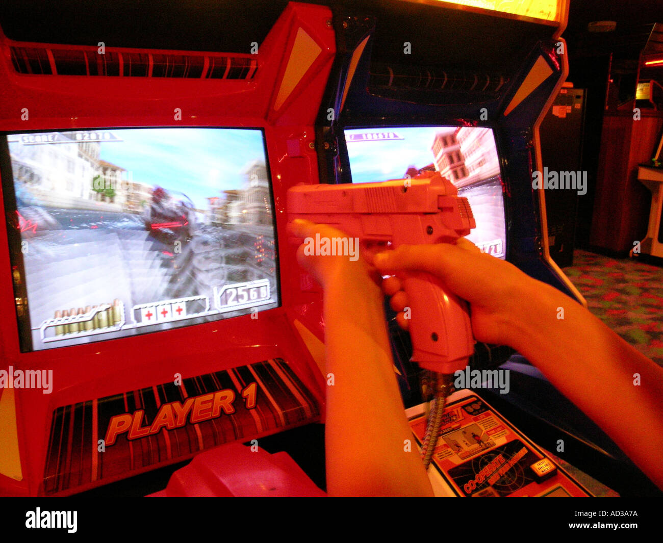 Boys using replica guns at arcade game, UK Stock Photo - Alamy