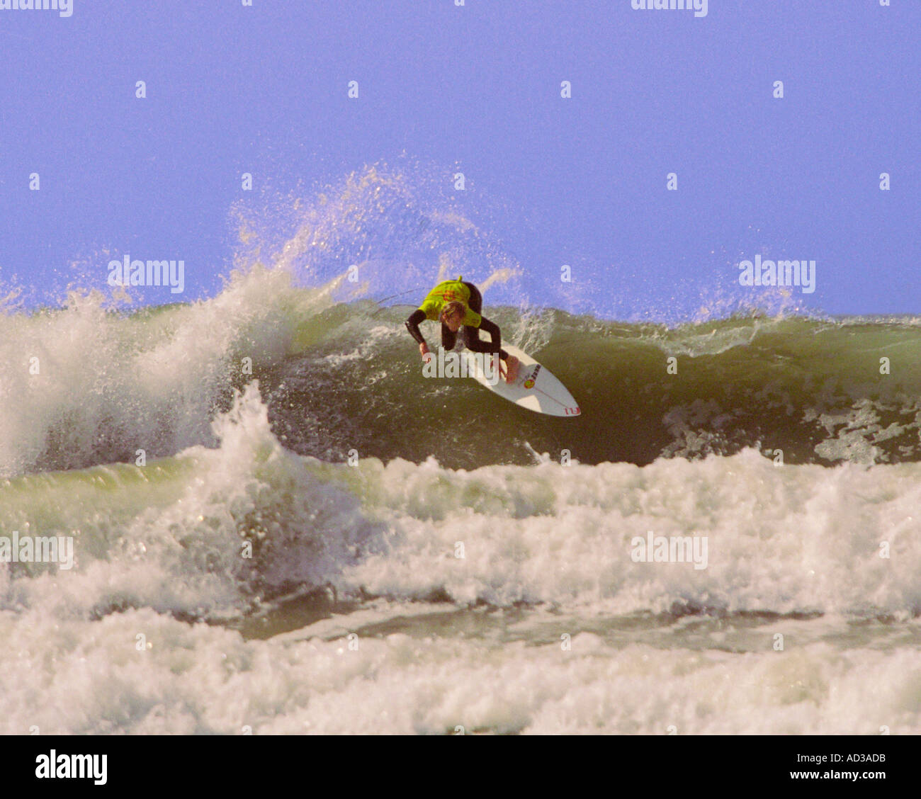 Surfer flies off the lip of breaking wave at speed with spray flying ...
