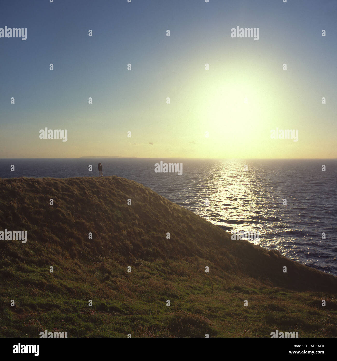 Lone figure looking out to sea hi-res stock photography and images - Alamy